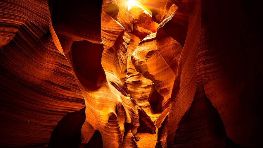 Dynamic sandstone formations highlighted by light in Antelope Canyon