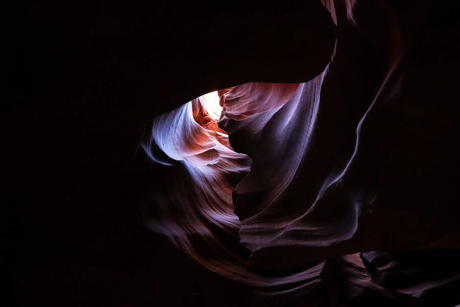 Light illuminating eroded sandstone walls in Antelope Canyon