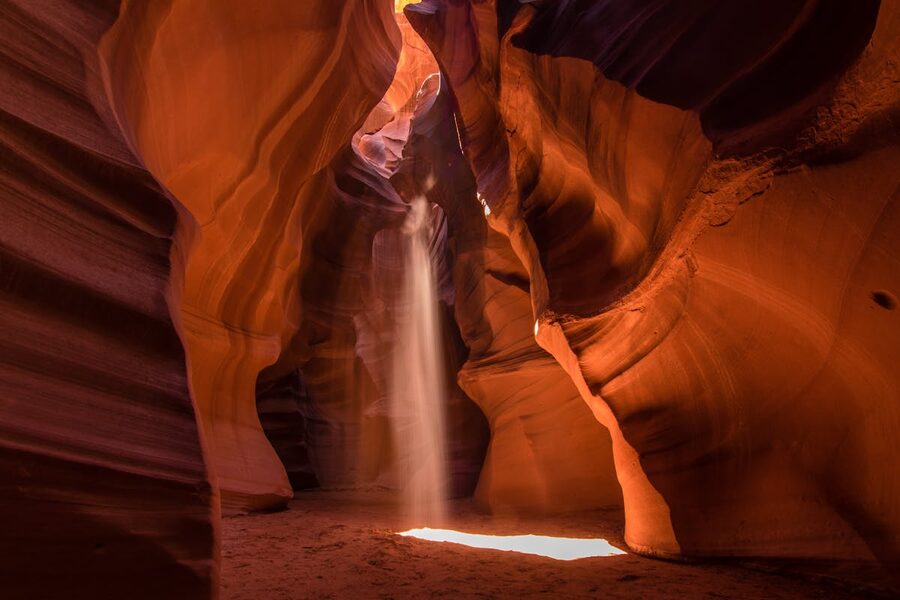 Light beams through red sandstone walls in Antelope Canyon