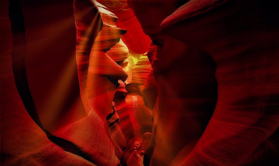 Red rock formations in Antelope Canyon with dramatic lighting
