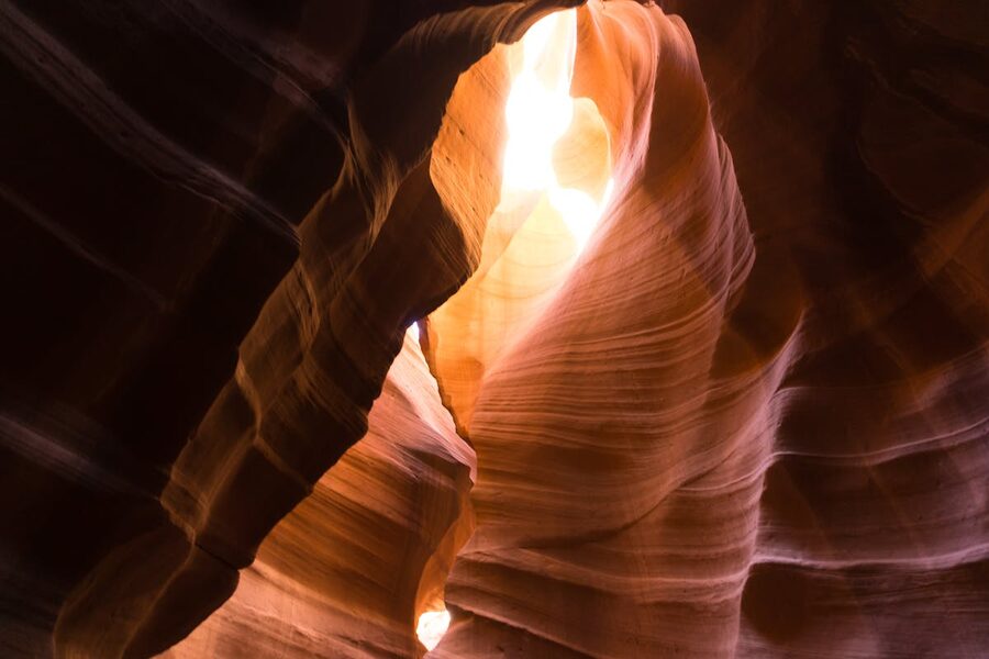 Sunlit rock formations creating patterns and colors in Antelope Canyon
