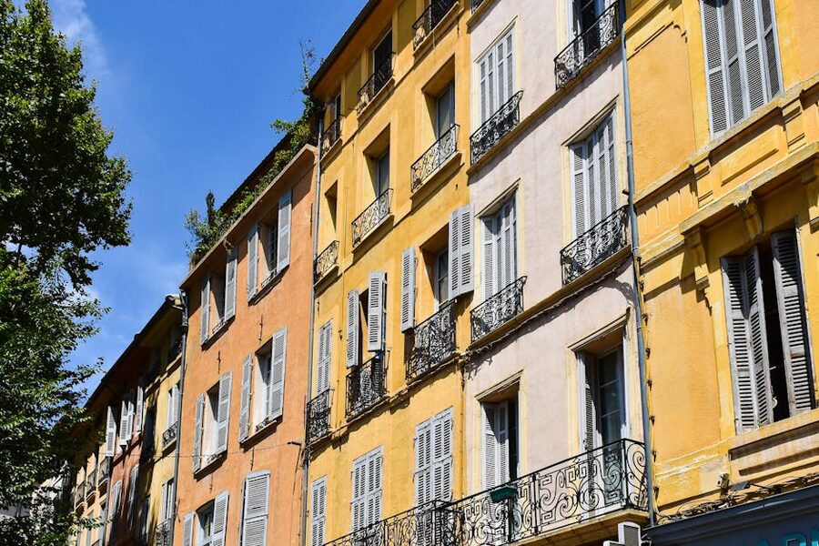 Pastel-coloured facades on a street in Aix-en-Provence