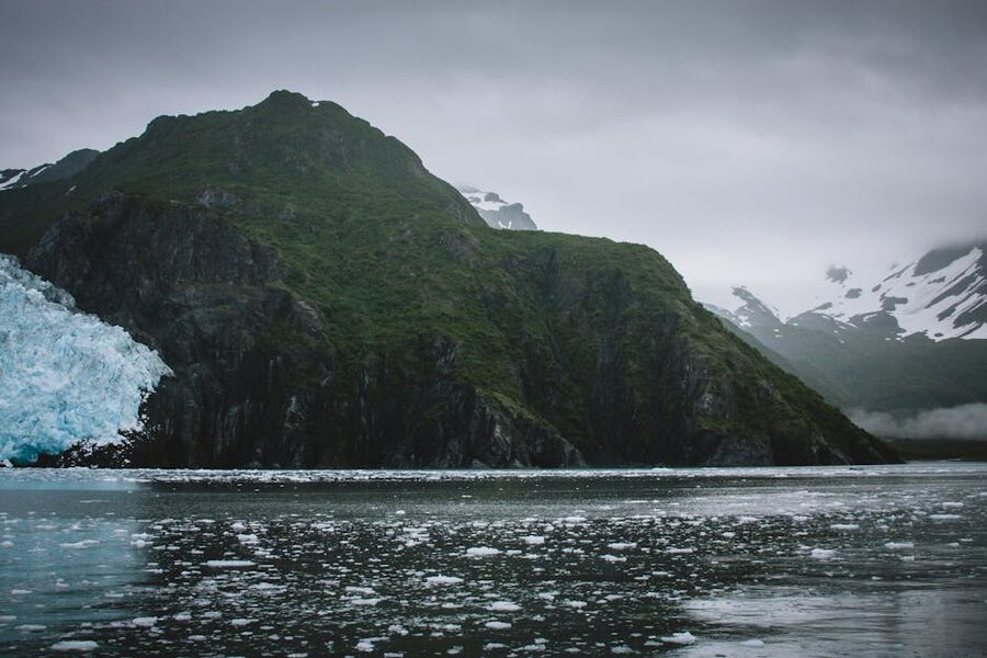 Alaska glacier and rugged mountains reflected in water