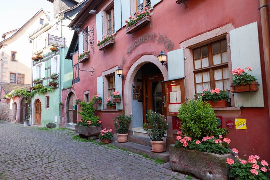 Riquewihr cobblestone street with flowers Alsace