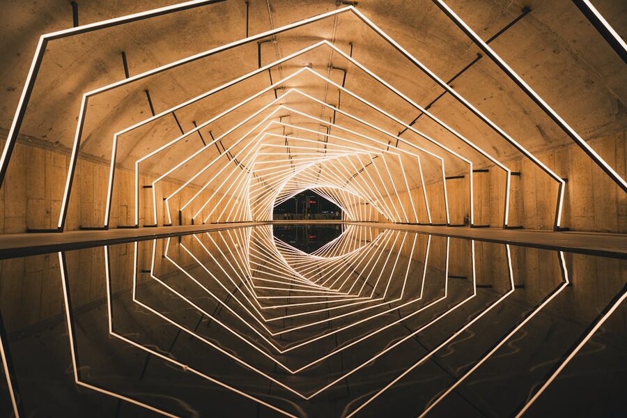 Geometric tunnel with LED light patterns and reflective water