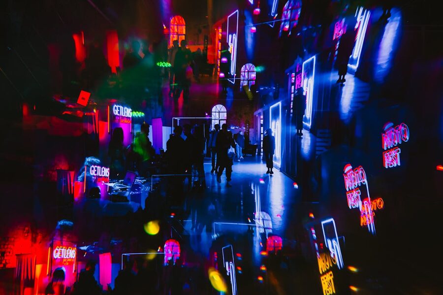 Art gallery with kaleidoscopic neon lights and people