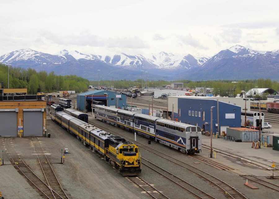 Anchorage train yard with snow-capped mountains in background