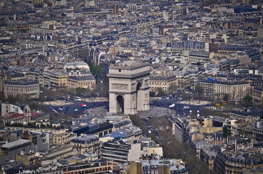 Aerial view of Arc de Triomphe surrounded by Parisian Haussmann architecture
