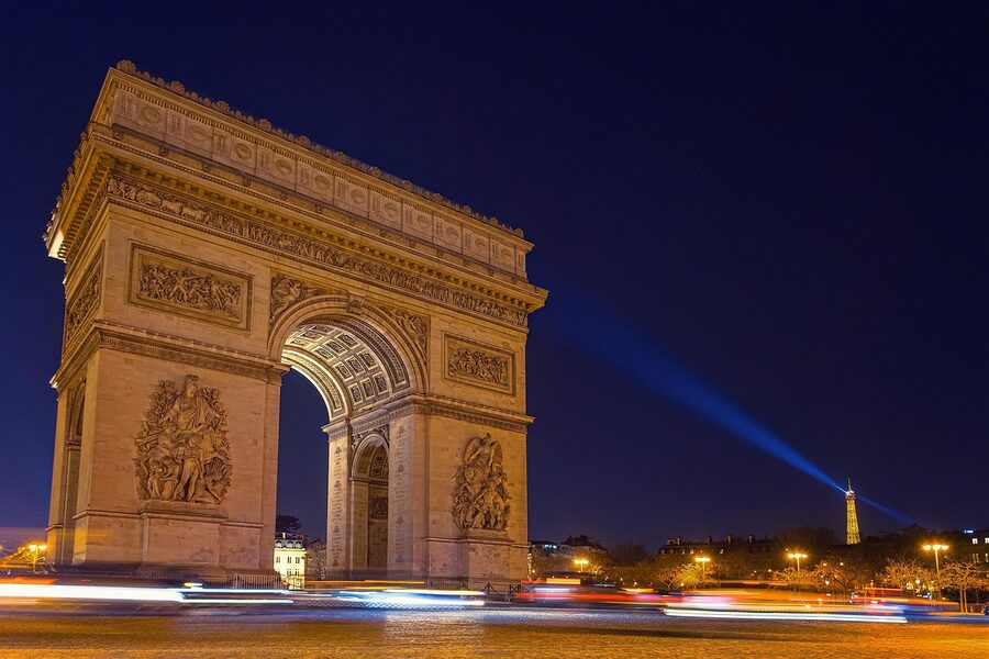 Long exposure of Arc de Triomphe at night with light trails