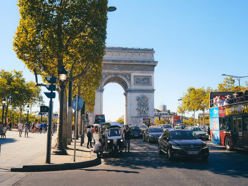 Tourists walking around Arc de Triomphe in Paris
