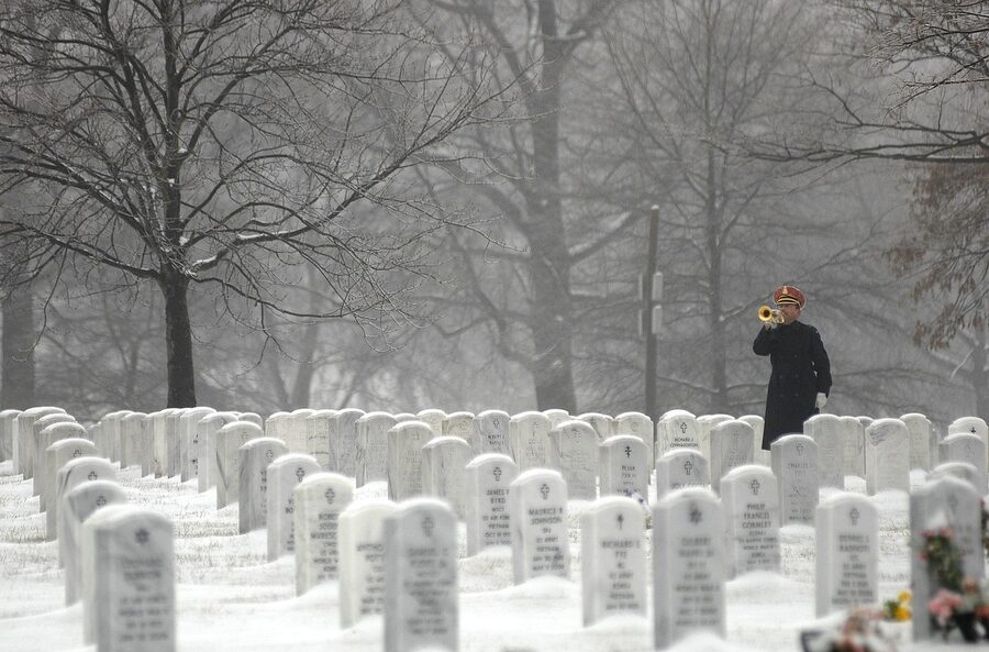 Bugler playing Taps at Arlington in winter snow