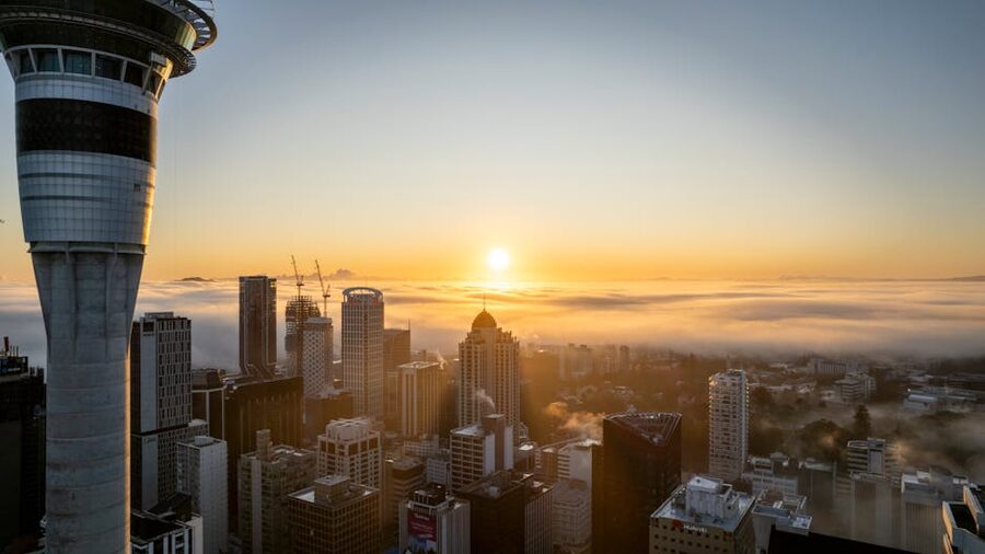 Sky Tower Auckland at sunrise rising above fog
