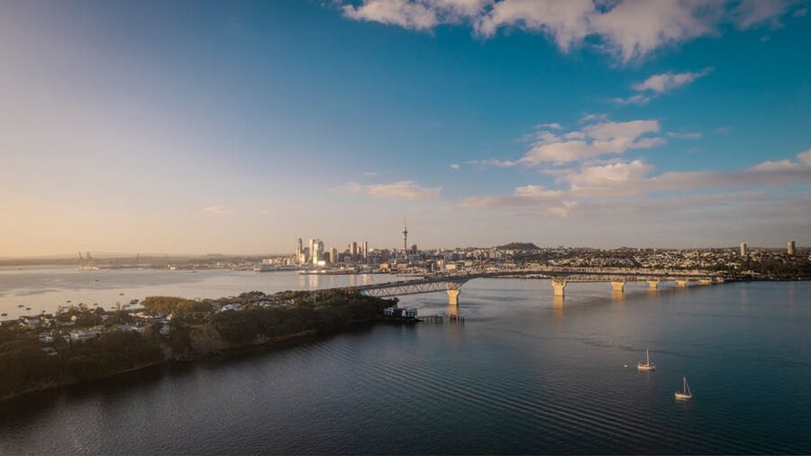 Auckland skyline and Harbour Bridge at dusk before a Hobbiton Waitomo day tour