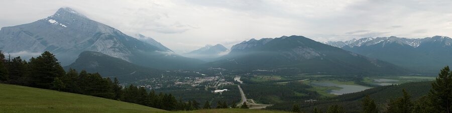 Highway approach to Banff town with Canadian Rockies panorama