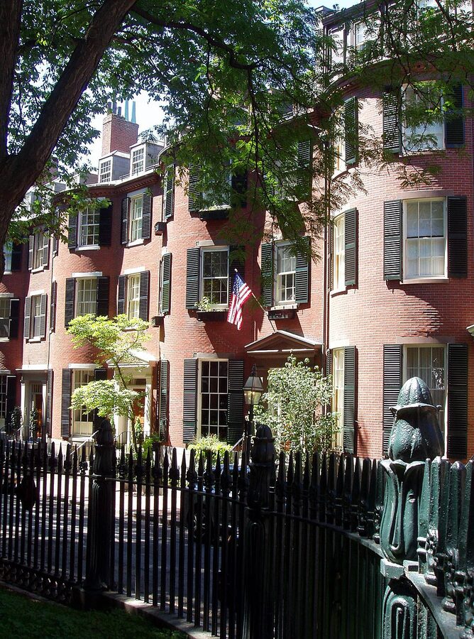 Louisburg Square in Beacon Hill Boston with brick row houses and gas lamps