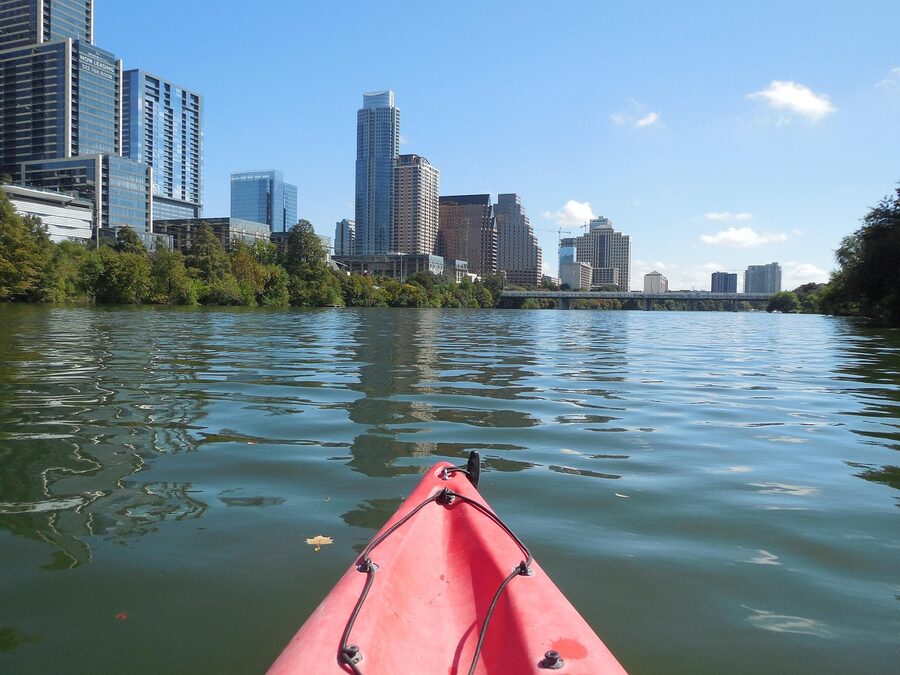 Kayaker on the Colorado River with Austin skyline