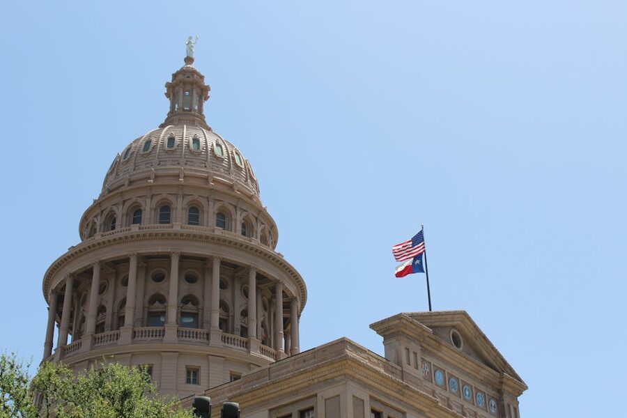 Texas State Capitol dome and flags Austin