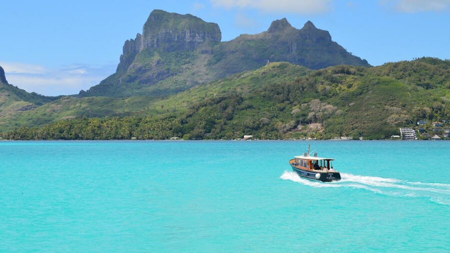 Motorboat cruising the turquoise water of Bora Bora lagoon