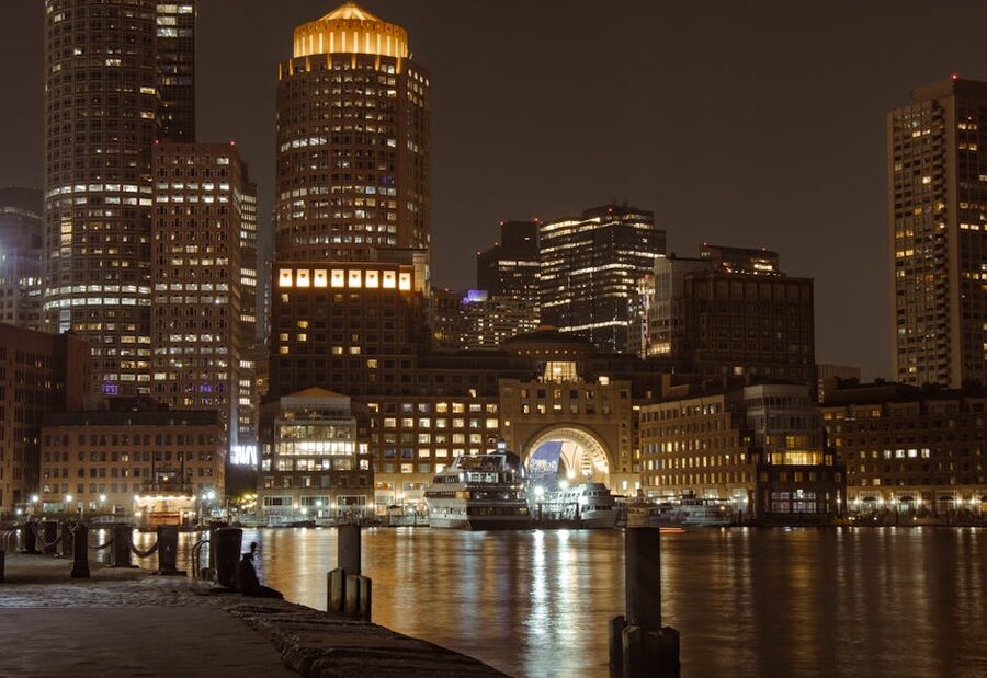 Boston harbor and skyline illuminated at night from Fan Pier Park