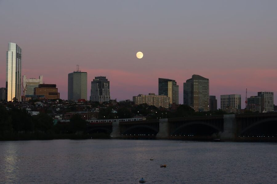 Boston skyline with full moon over Charles River