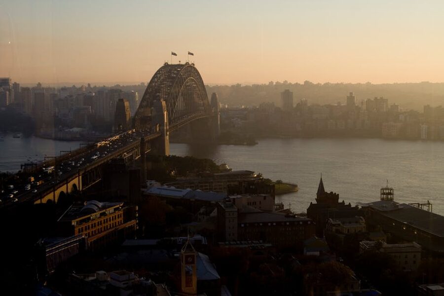 Aerial view of Sydney Harbour Bridge and the city at sunset