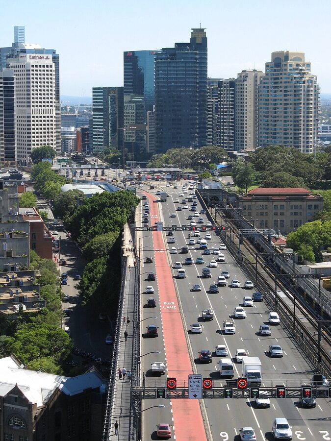Eight lanes of traffic crossing the Sydney Harbour Bridge seen from above