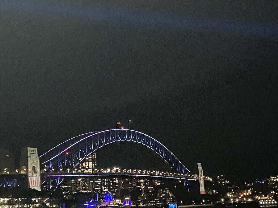 Sydney Harbour Bridge lit with coloured lights during Vivid Sydney festival