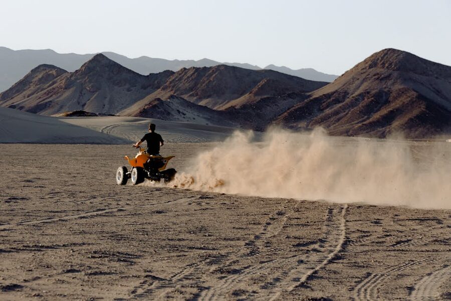 ATV kicking up dust trails in Baja desert