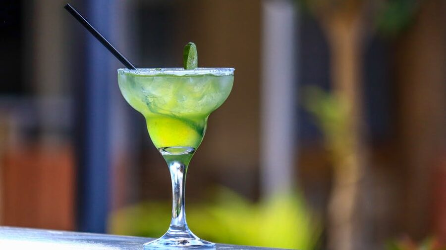 Margarita cocktail with lime wedge on a sunset sail