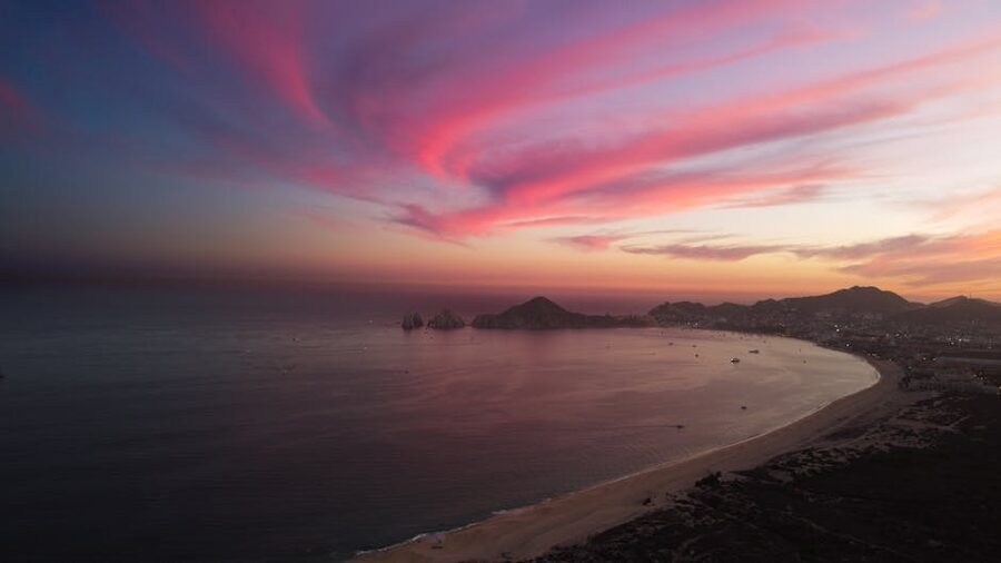 Pink clouds over Cabo San Lucas coastline at sunset
