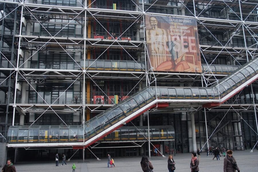 The exterior glass escalator tube of the Centre Pompidou with people inside