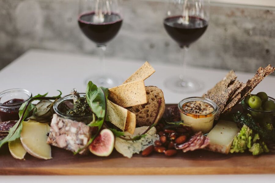 Charcuterie board paired with red wine glasses