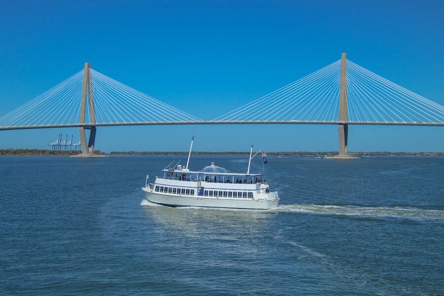 White ferry on Charleston Harbor with the Arthur Ravenel Jr Bridge behind it