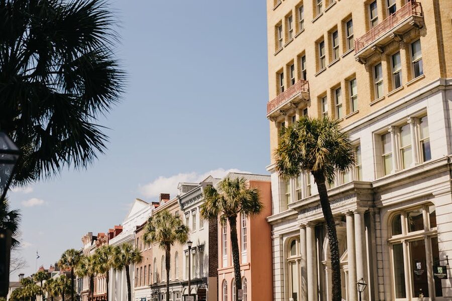 Charleston SC historic street with palm trees and pastel buildings