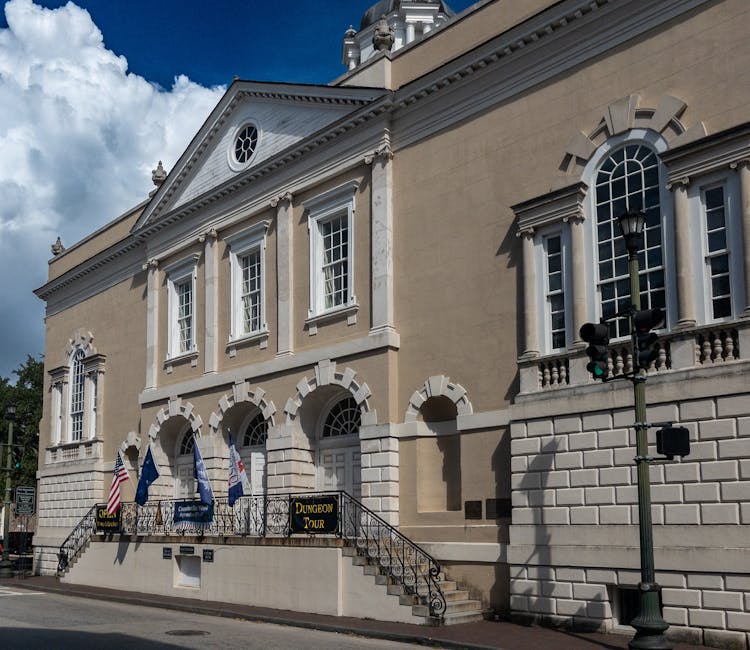 Charleston historic colonial building with a dungeon tour sign and flags
