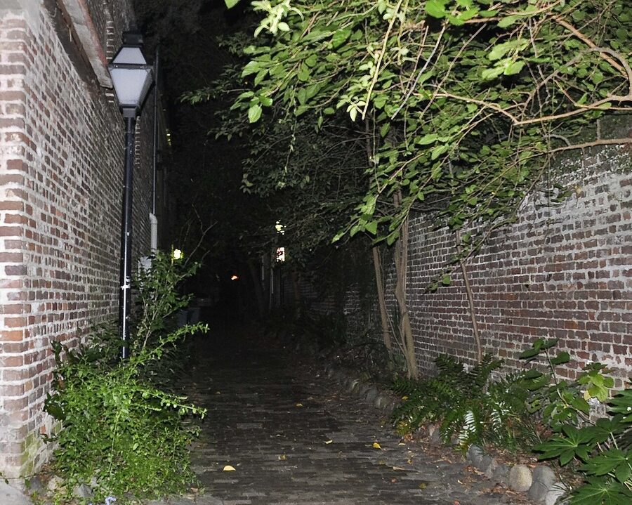 Philadelphia Alley Charleston at night, narrow cobblestone alley between brick walls