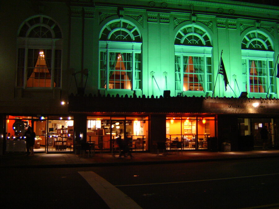 Charleston South Carolina street at evening with warm lantern light on brick buildings