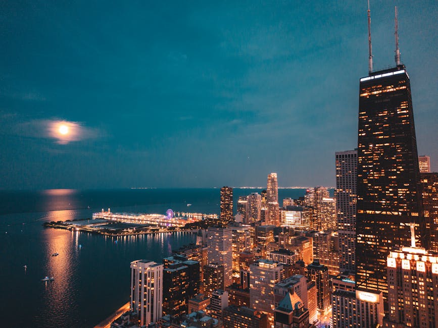 Chicago skyline under a full moon with lakefront lights