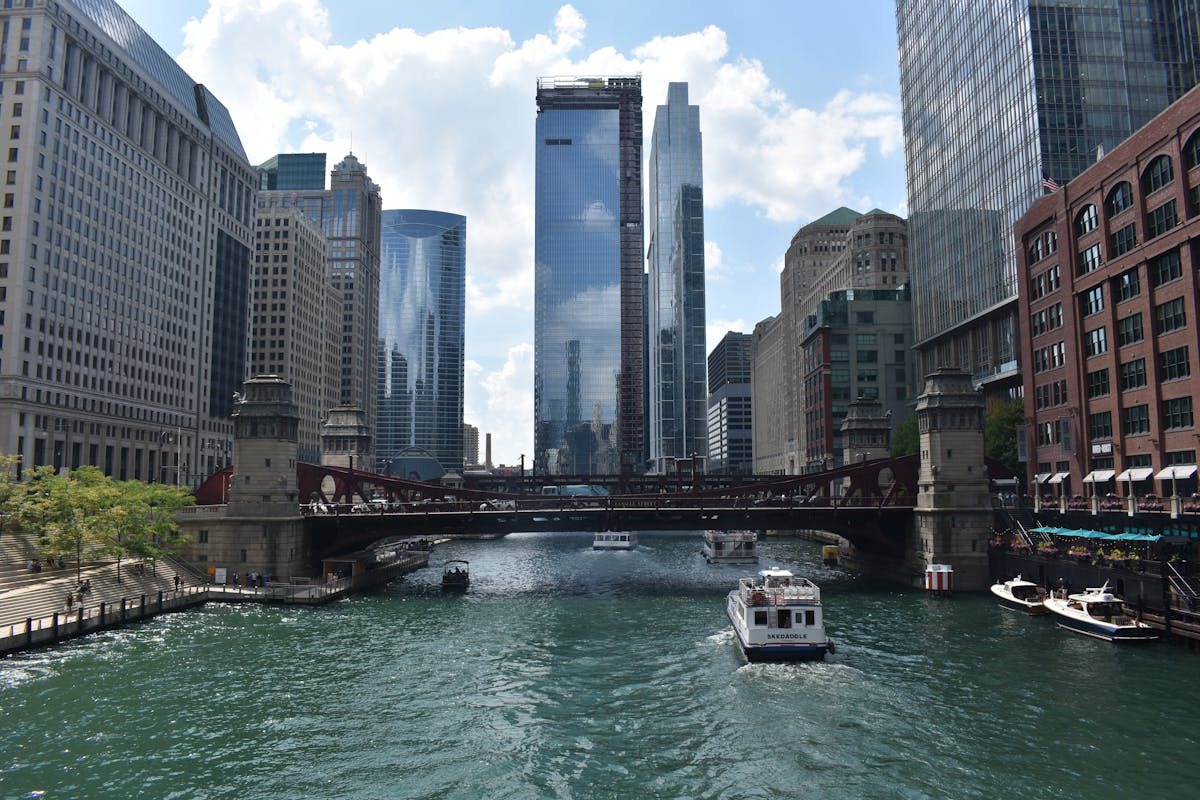 Chicago River flanked by towering skyscrapers including Trump Tower on a sunny day