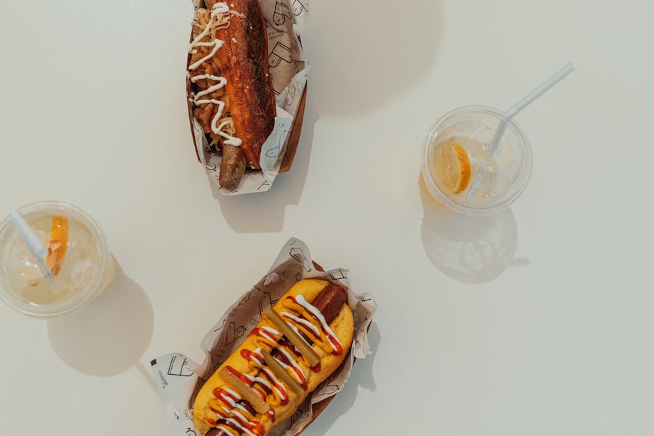 Gourmet hot dogs with condiments and drinks