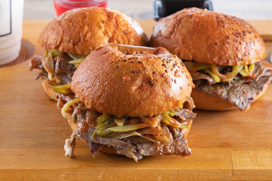 Beef sandwich with pickles on wooden board