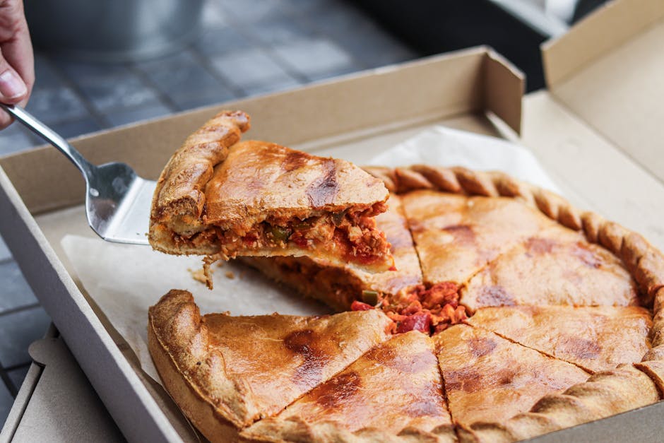 Close-up of deep dish pizza slice being served