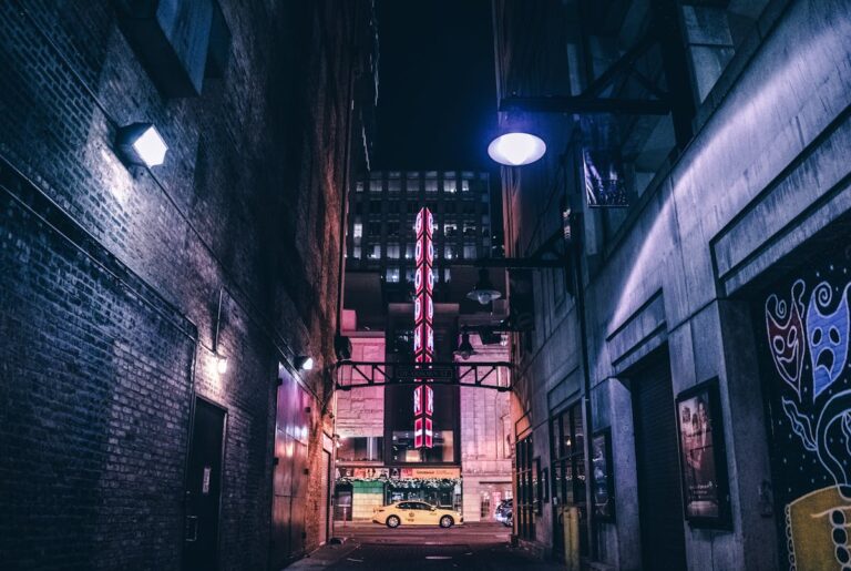 Moody Chicago alley at night with vintage theater signs and dramatic lighting