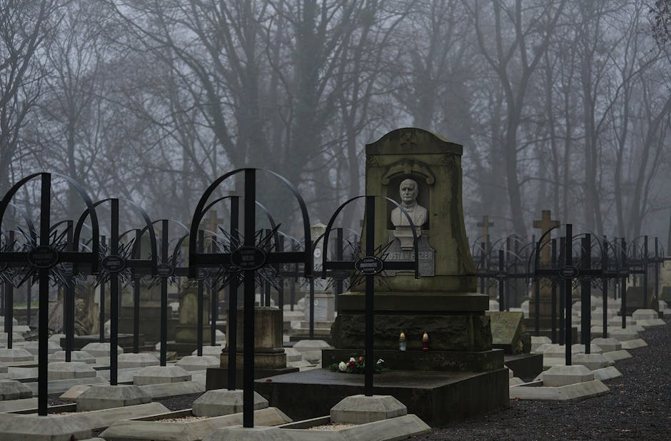 Atmospheric fog over gravestones and sculptures in a historic cemetery