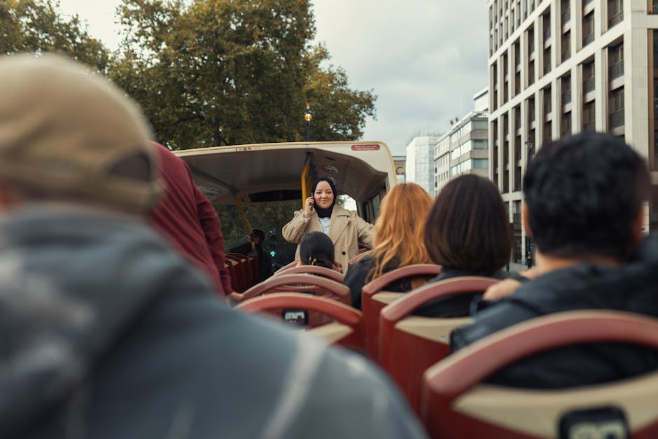 Group of people enjoying a city tour on an open-top sightseeing bus