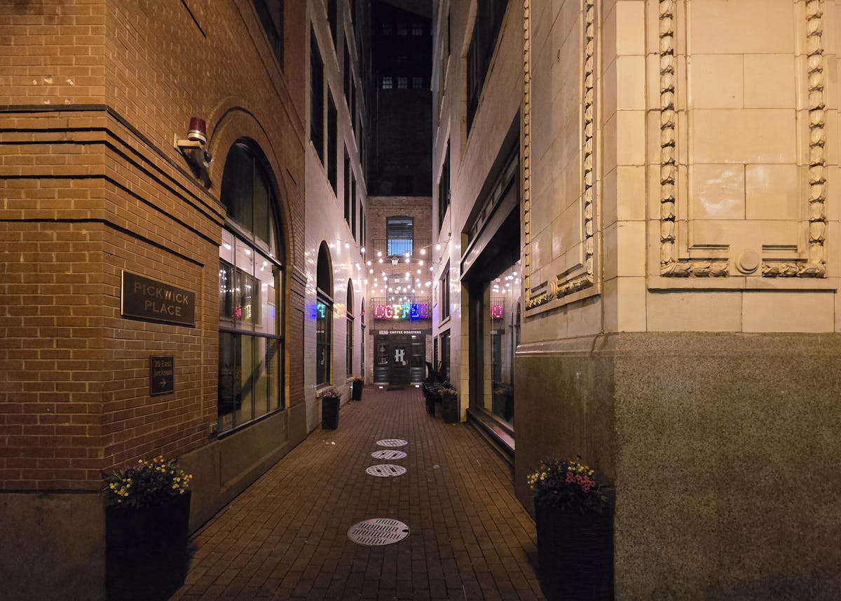 Illuminated Pickwick Place alleyway at night in Chicago