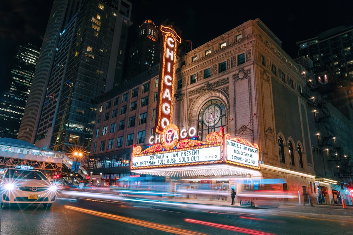 Illuminated Chicago Theater sign glowing against the night sky