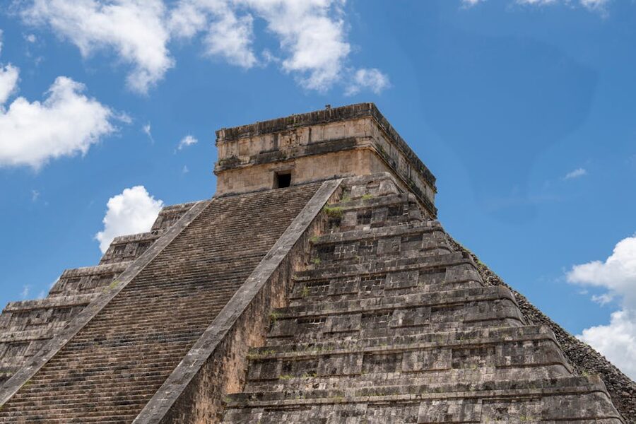 El Castillo stepped pyramid at Chichen Itza under bright blue sky