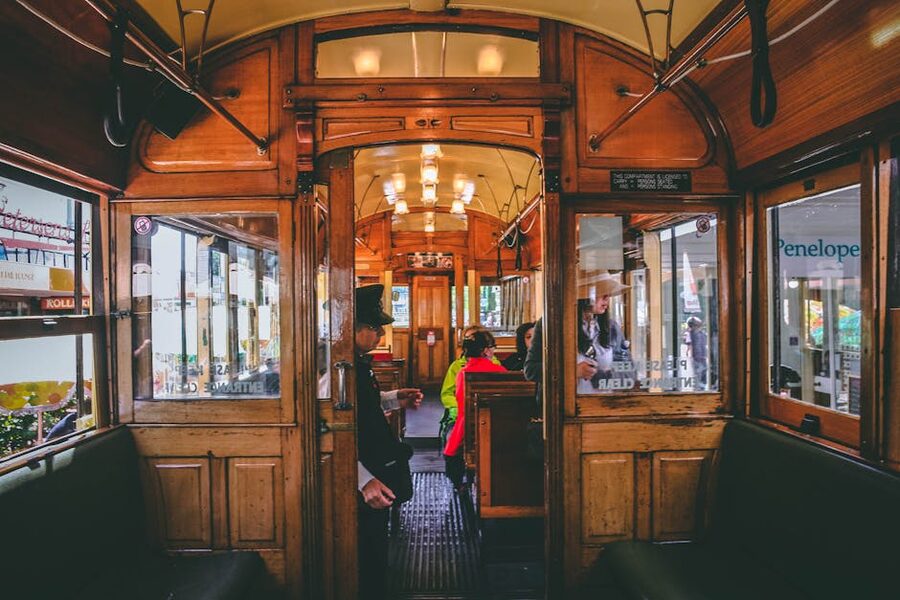 Inside a Christchurch heritage tram with passengers and wooden interior