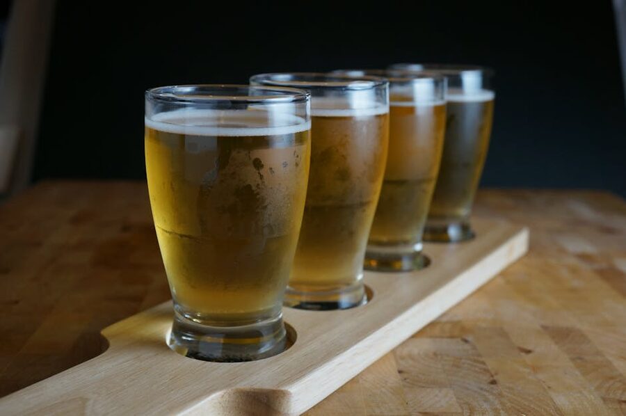 Craft beer flight on wooden paddle for tasting